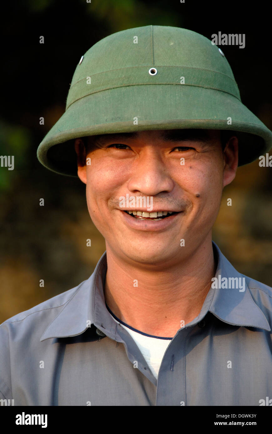 Smiling Vietnamese man wearing a Vietnamese helmet, portrait, Dien Bien ...