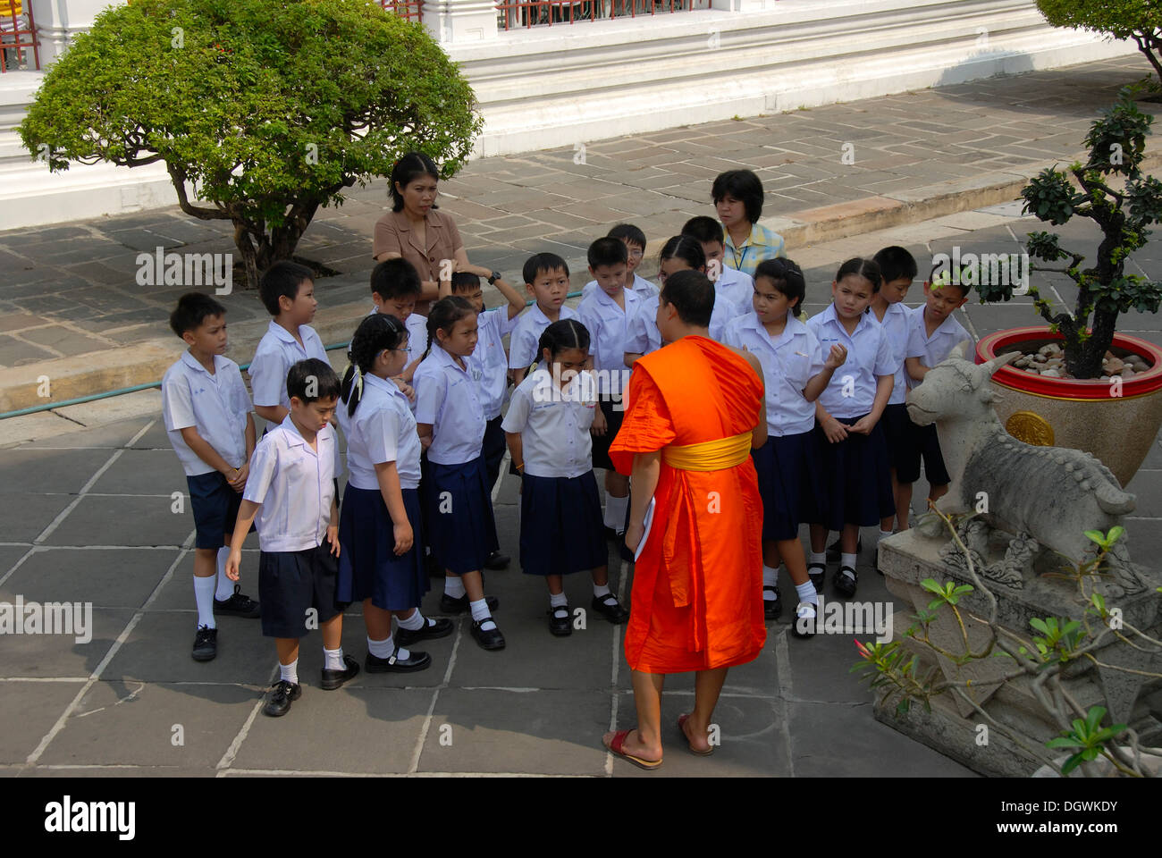 Theravada Buddhism, monk as the guide of a school class, orange robes ...