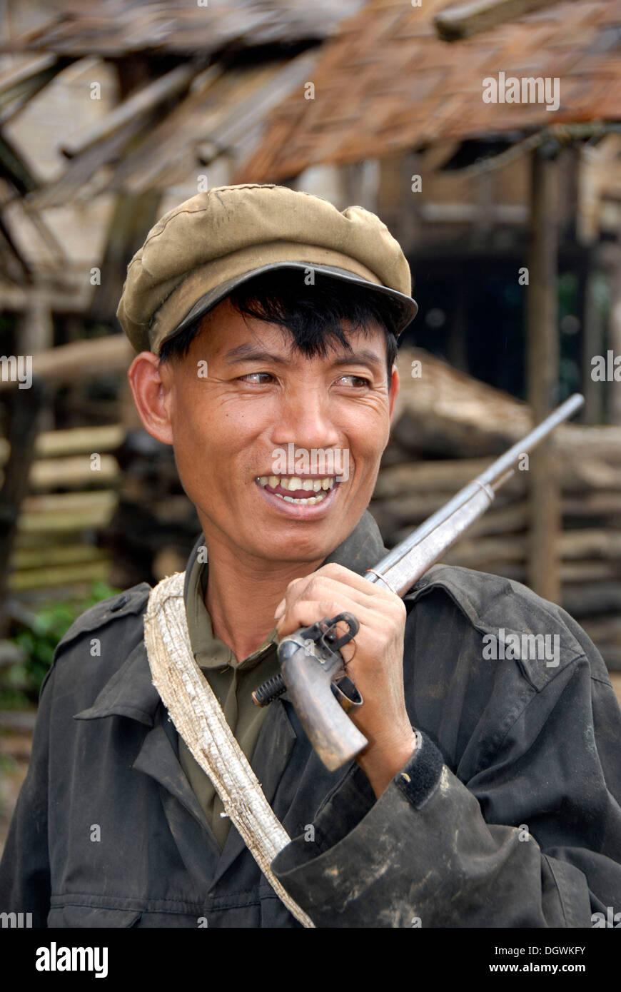 Hunter, man of the Akha ethnic group with a rifle, Ban Kokkheuang ...