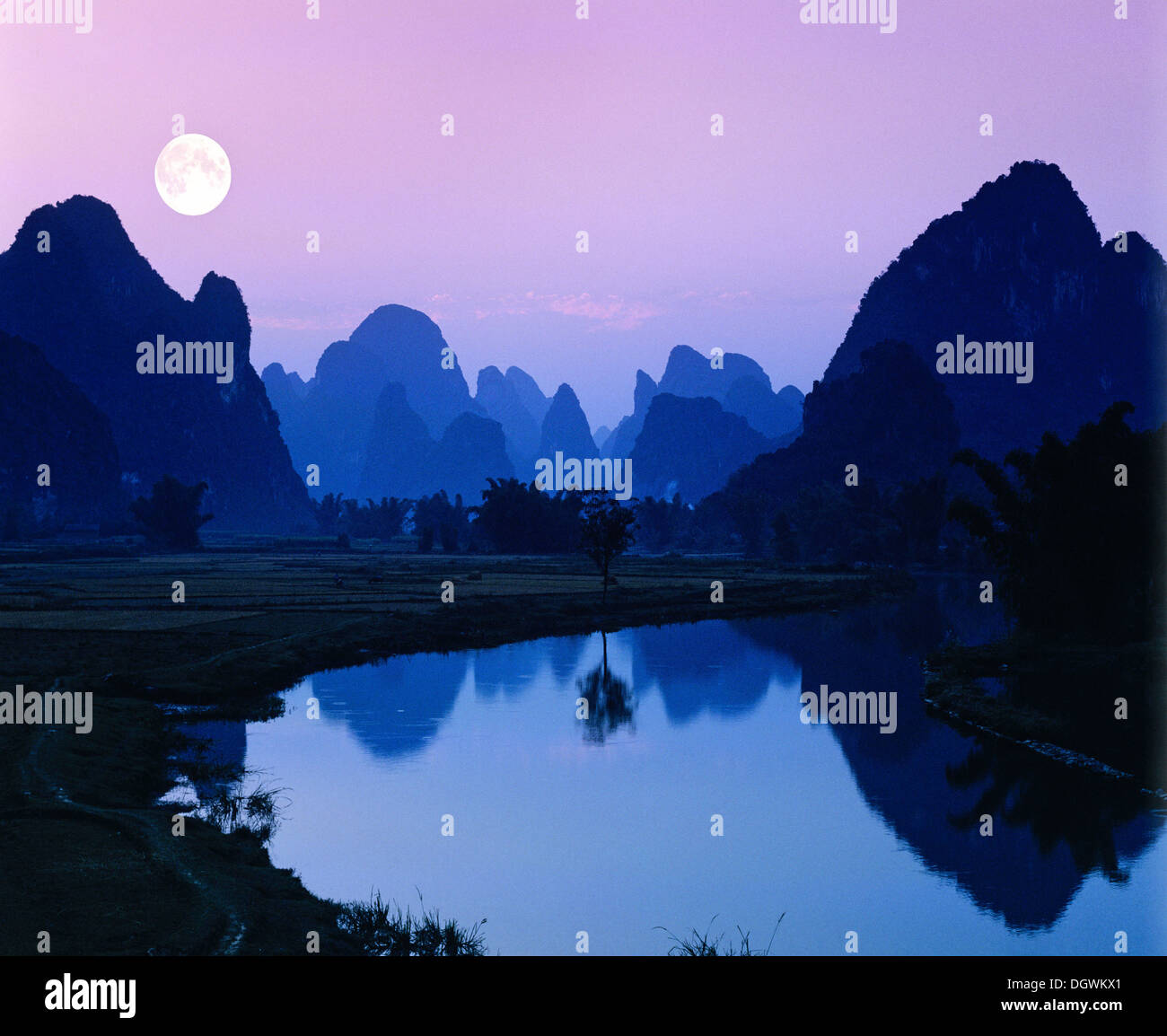 Karst mountain landscape along the Yulong River, full moon, Yangshuo ...