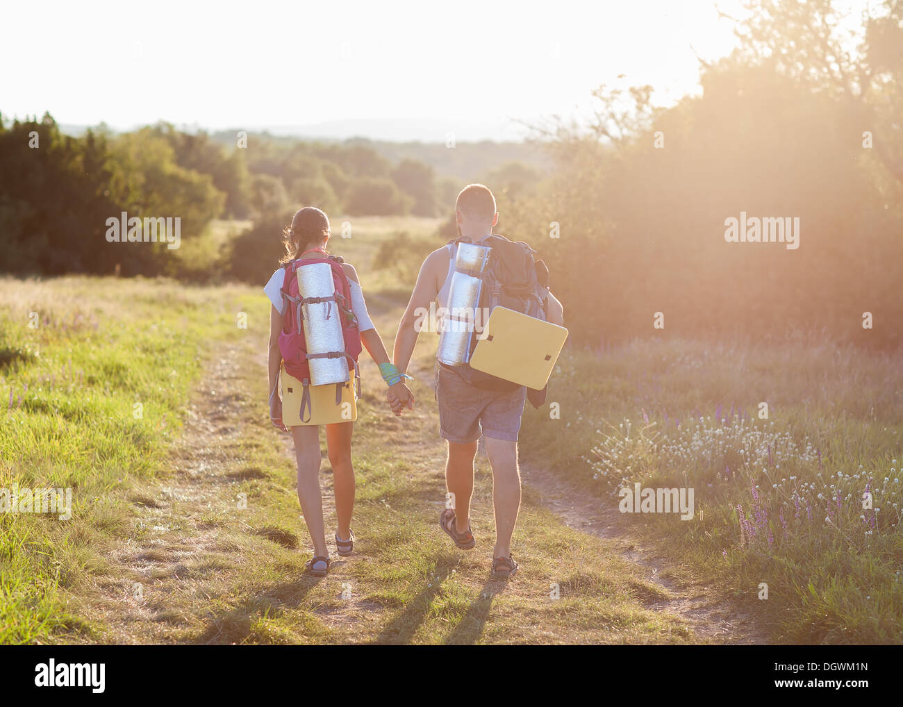 Two tourists make hiking the trail in the woods Stock Photo - Alamy
