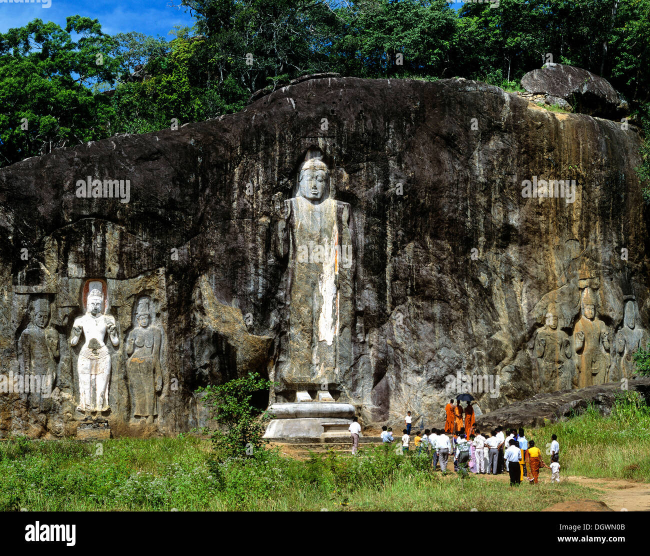 Buduruvagala, rock of Buddhist sculptures, monks and tourists standing ...