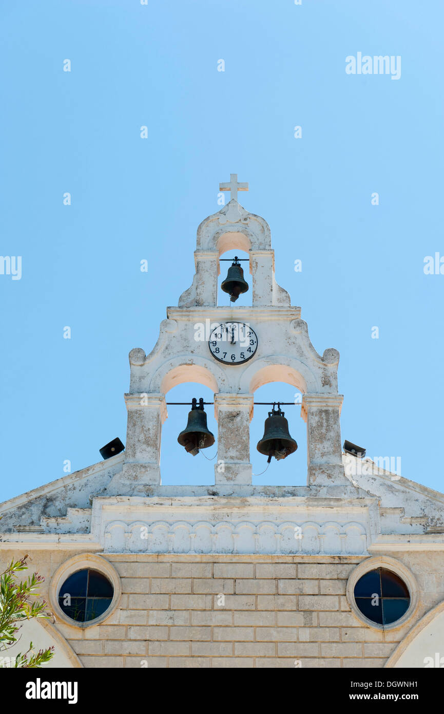 A Greek Orthodox church, bell tower with three bells, a clock and a ...