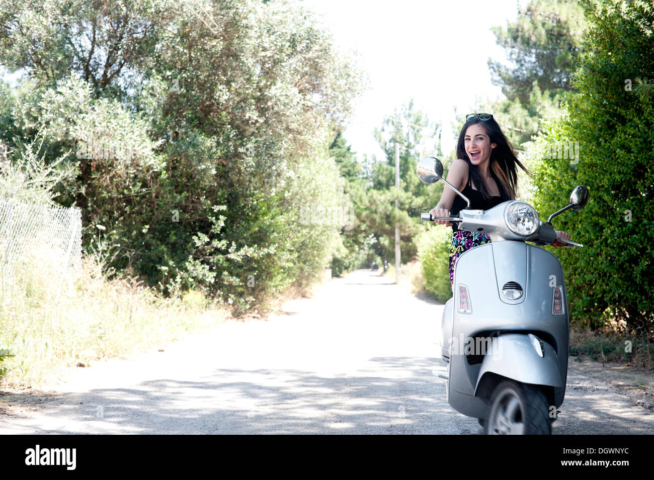 Young female enjoys a motorcycle ride Stock Photo - Alamy