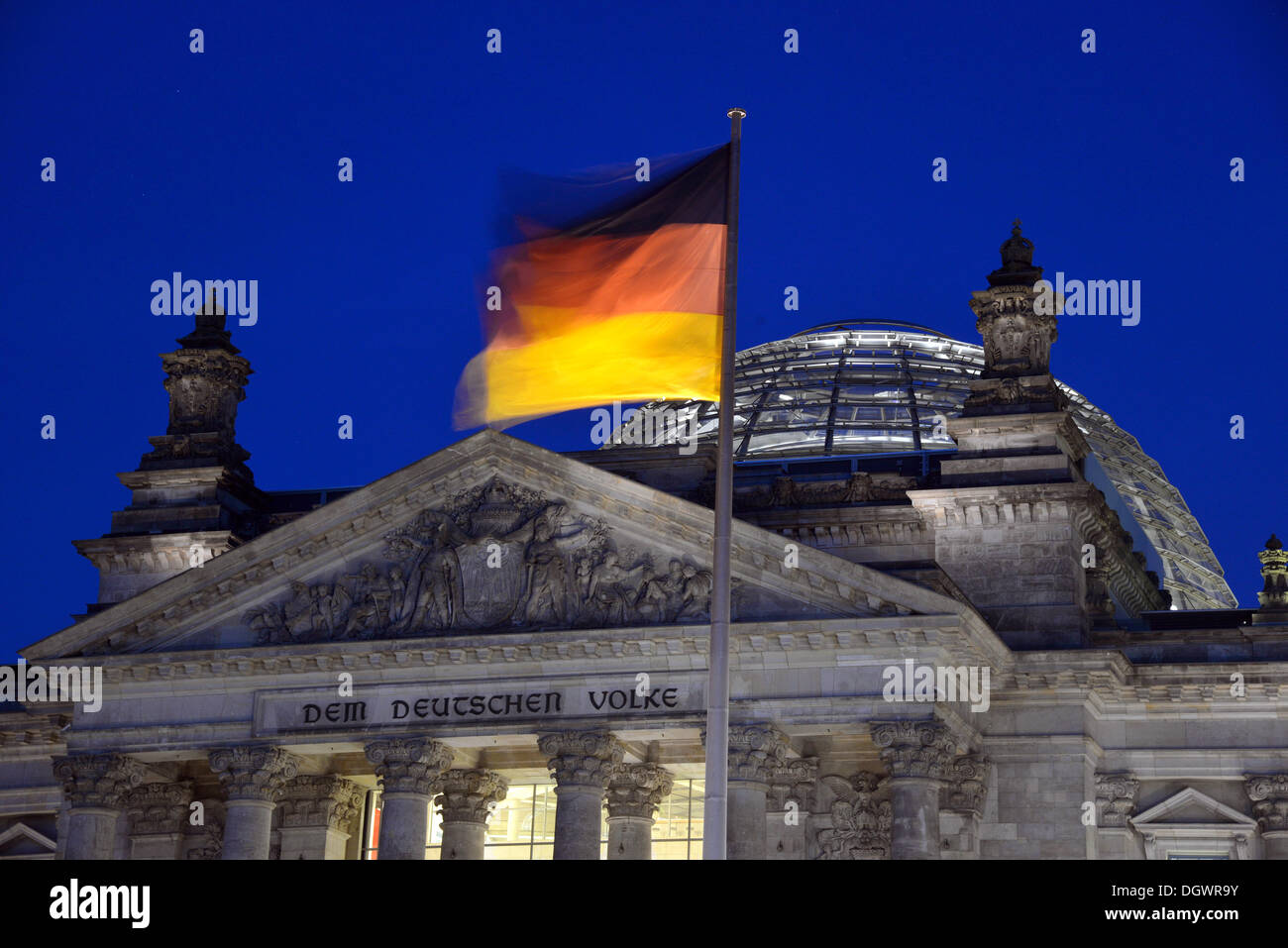 A German flag waves in the air above the entrance to the German ...