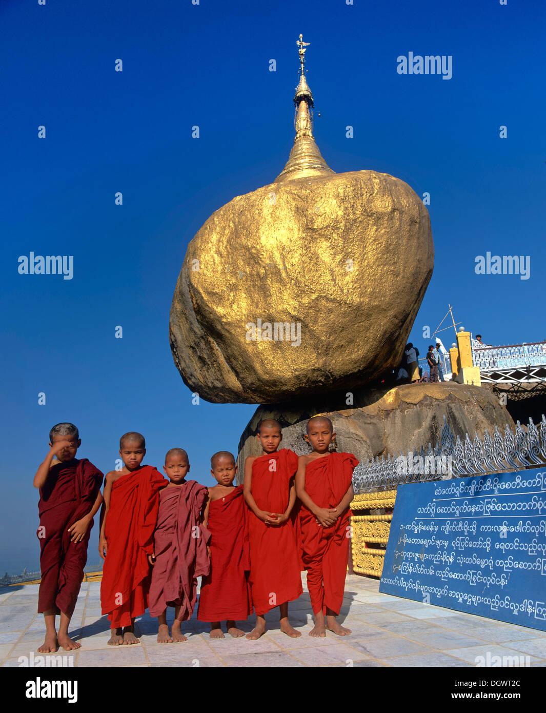 Buddhist monks, novices standing in front of the Golden Rock or ...