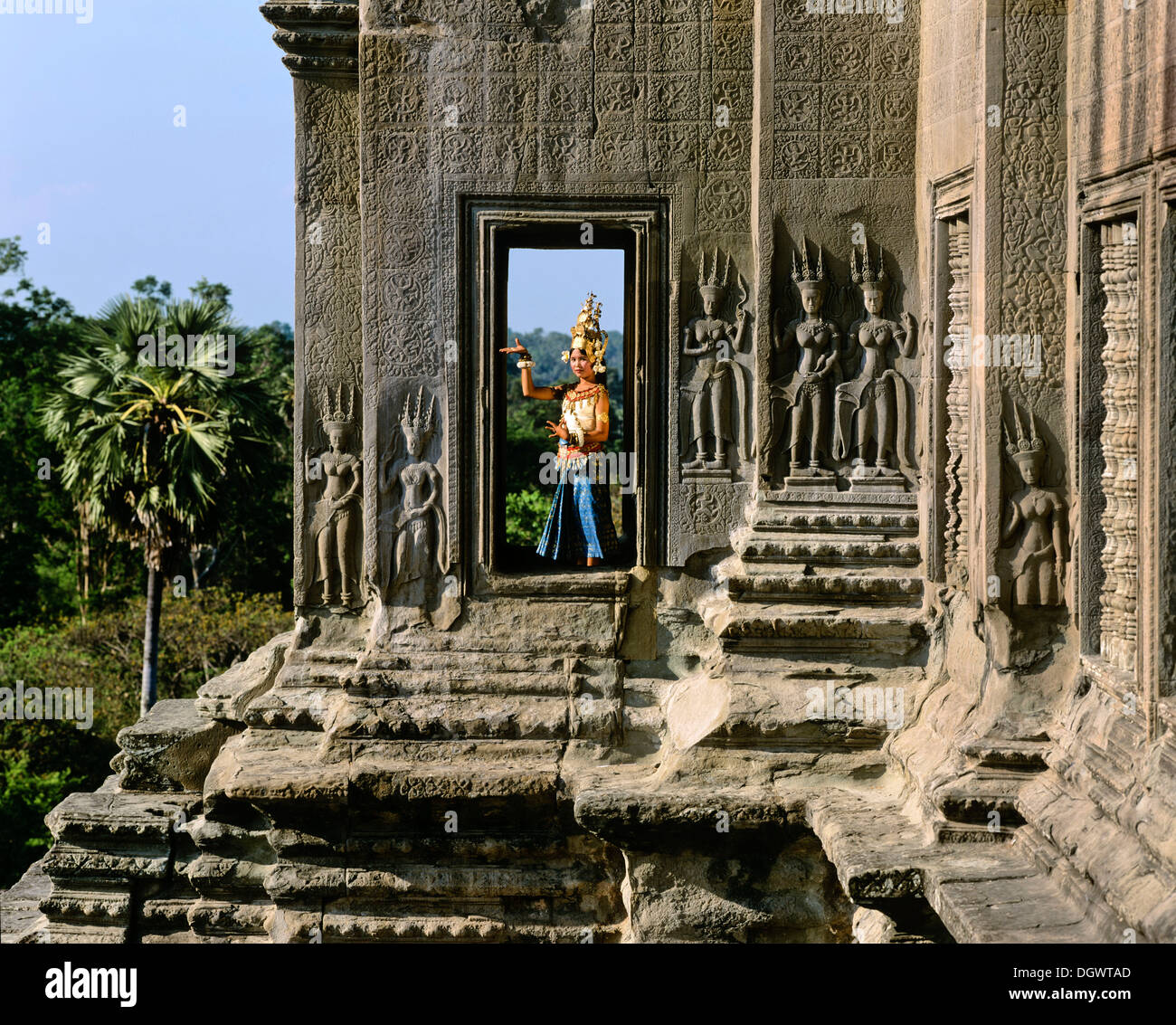 Temple dancer or apsara in a window of the temple of Angkor Wat beside ...