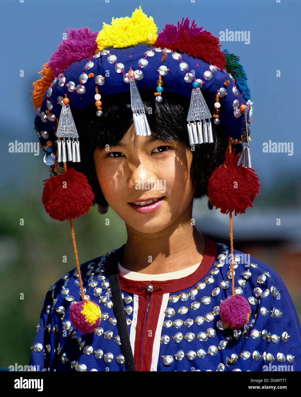 Lisu girl wearing a colourful headdress and the traditional costume of ...