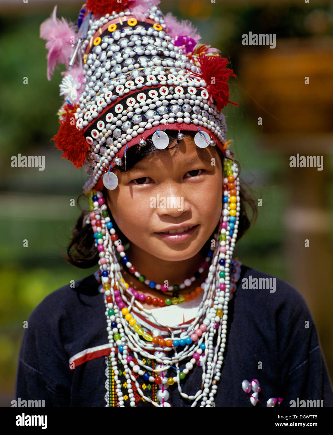 Akha girl wearing a colourful headdress and the traditional costume of ...