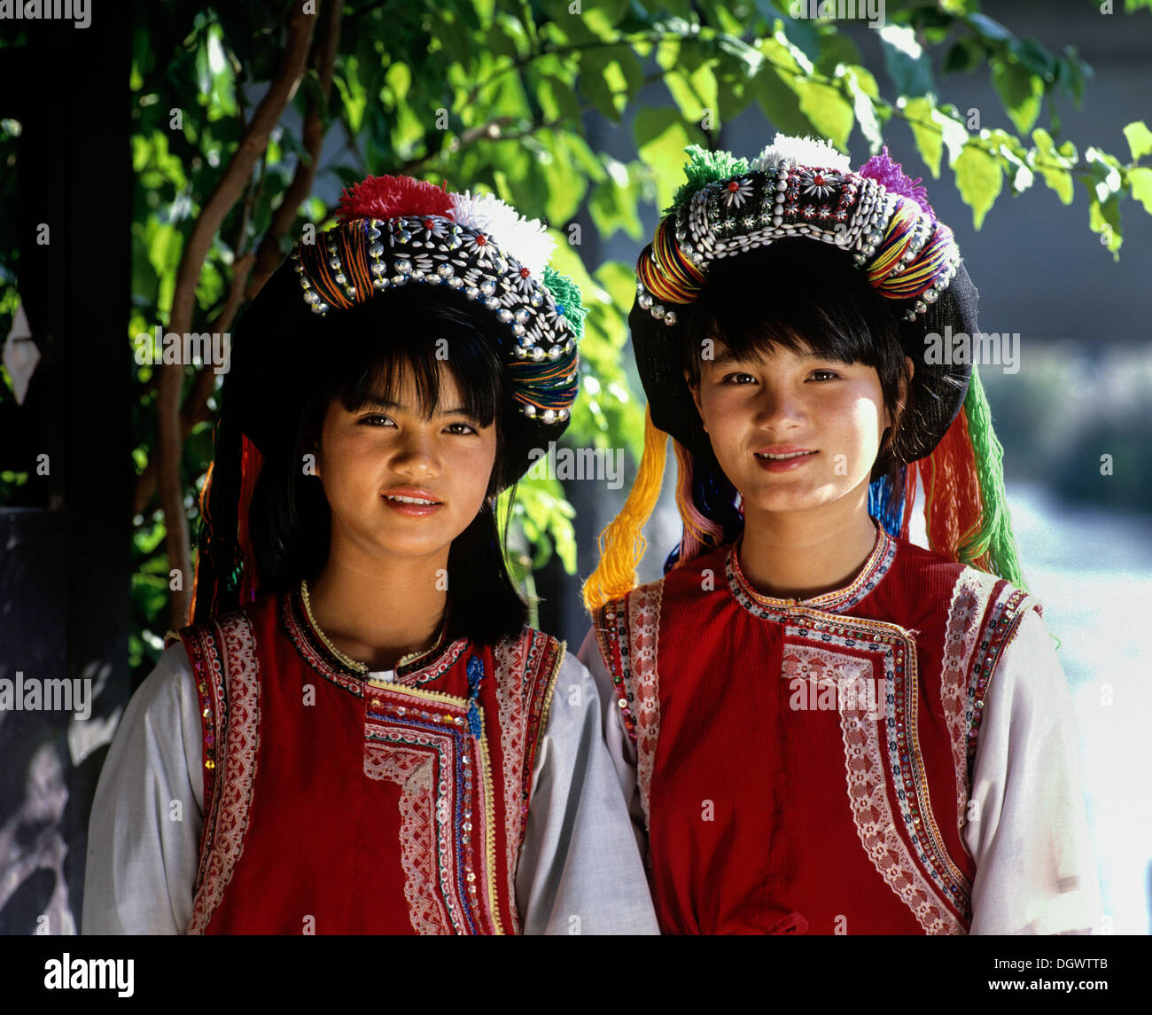 Two Lisu girls wearing colourful headdresses and the traditional ...