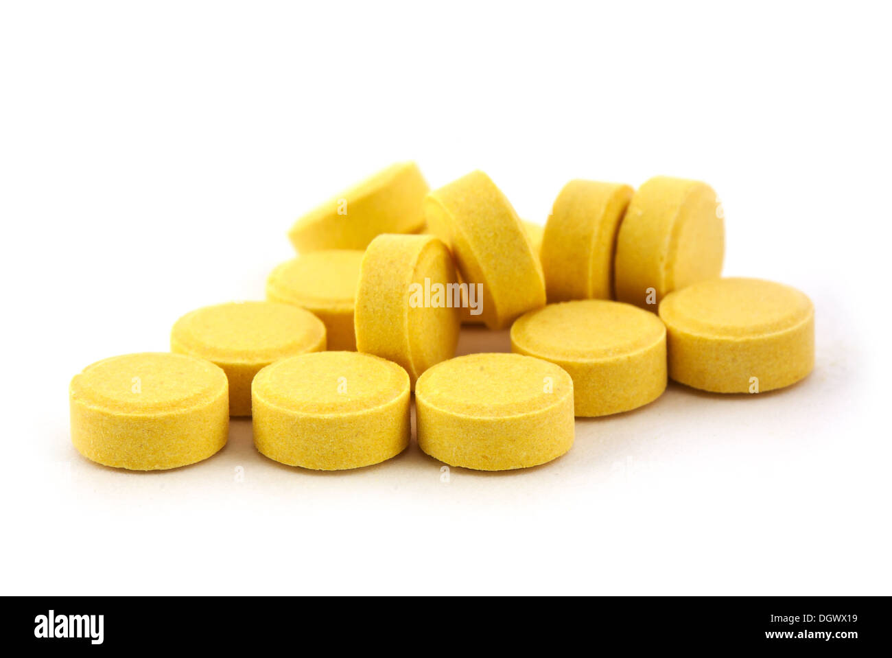 Yelow pills isolated on white Stock Photo - Alamy