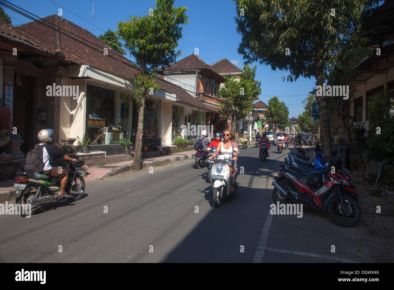 Traffic street Ubud Bali Indonesia motorbikes shops trade people drive ...