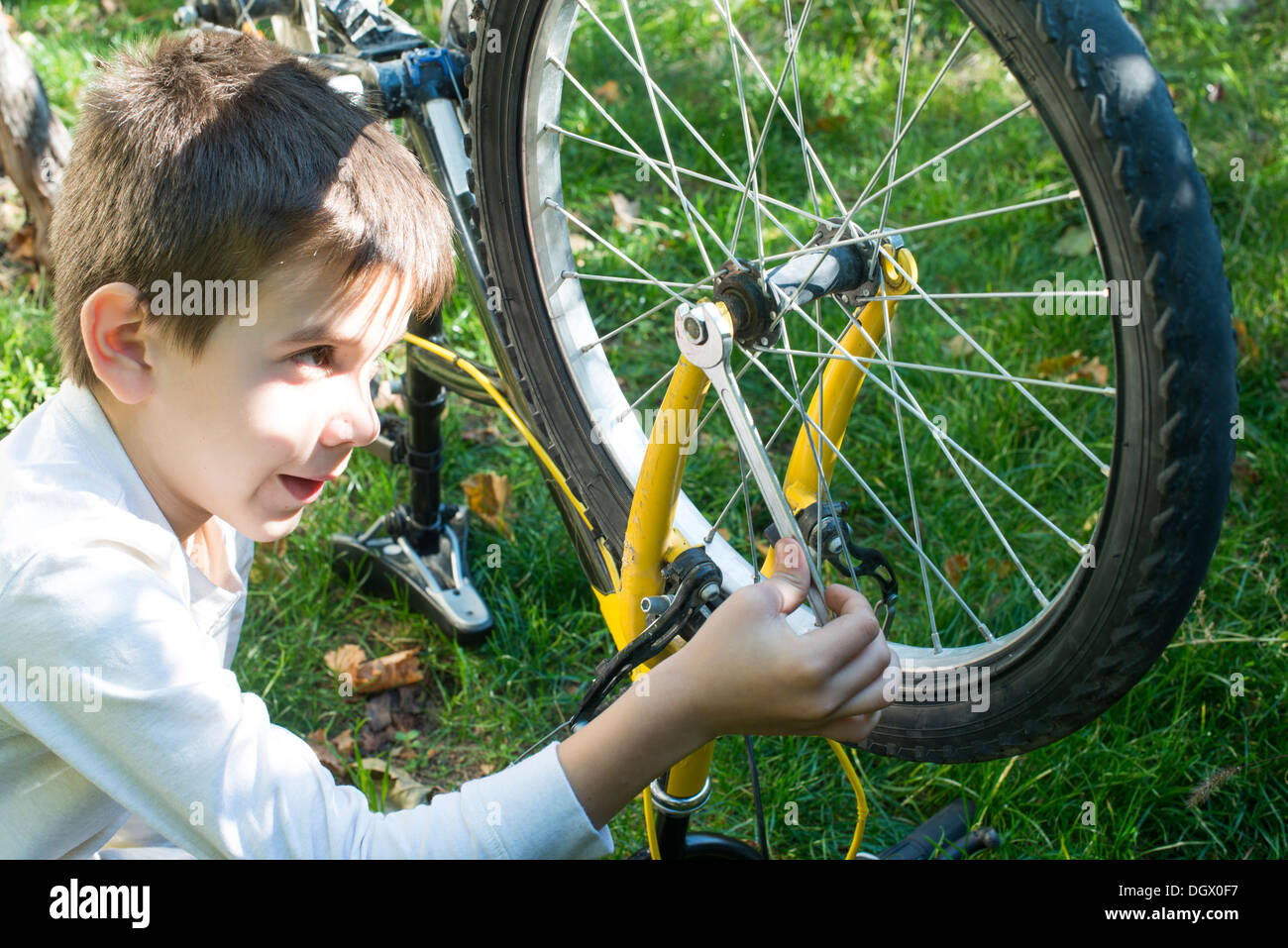 Child who fix bikes. Boy and bicycle Stock Photo - Alamy
