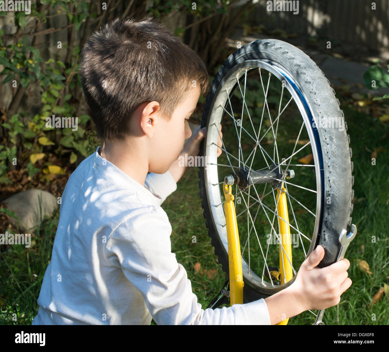 Child who fix bikes. Boy and bicycle Stock Photo - Alamy