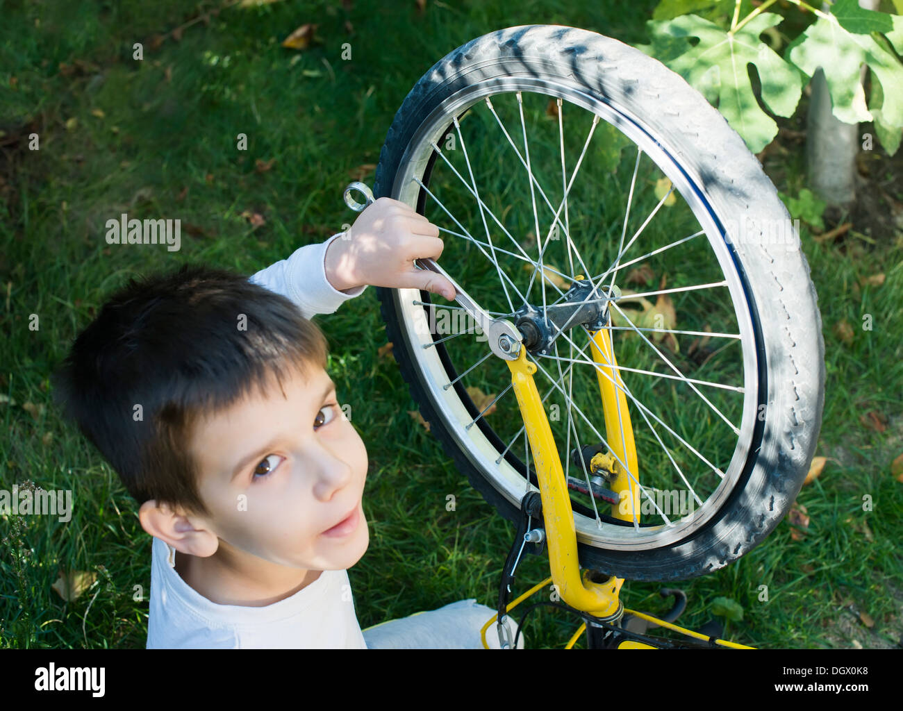 Child who fix bikes. Boy and bicycle Stock Photo - Alamy
