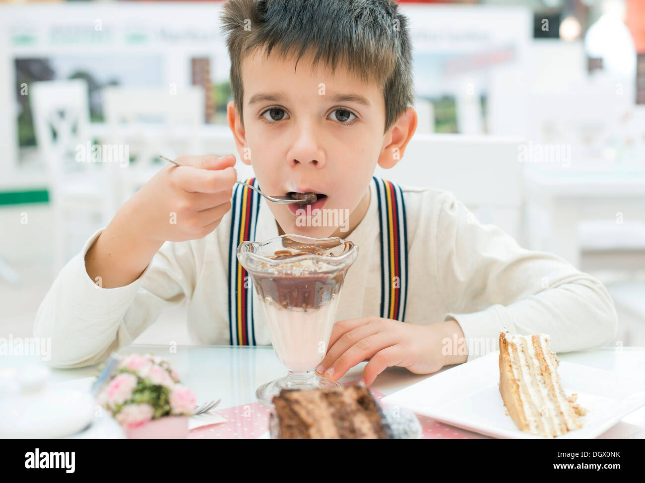 Child eat milk choco shake on a table Stock Photo - Alamy