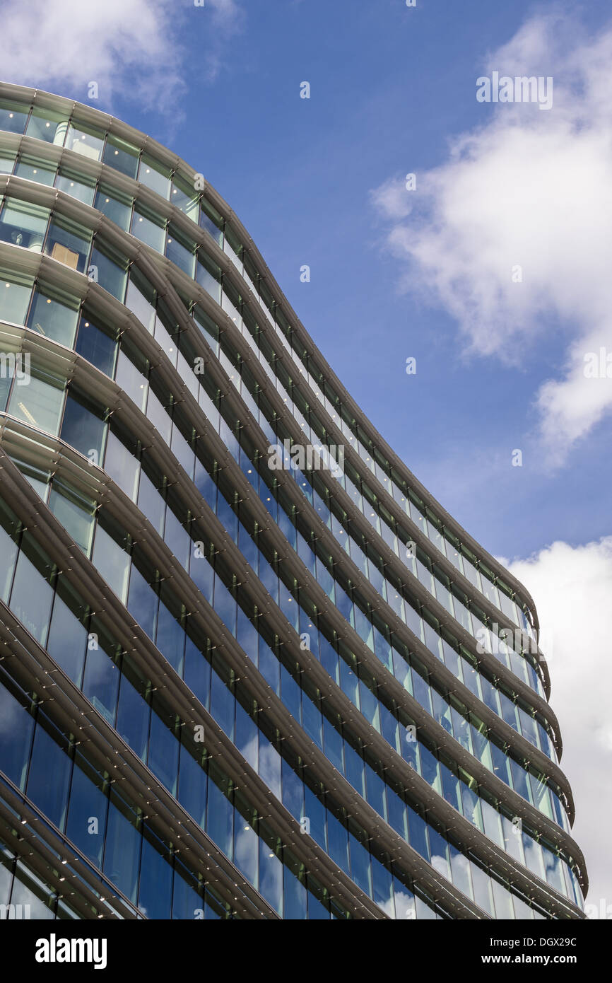 The curved cladding facade of One London Wall with reflections of a ...