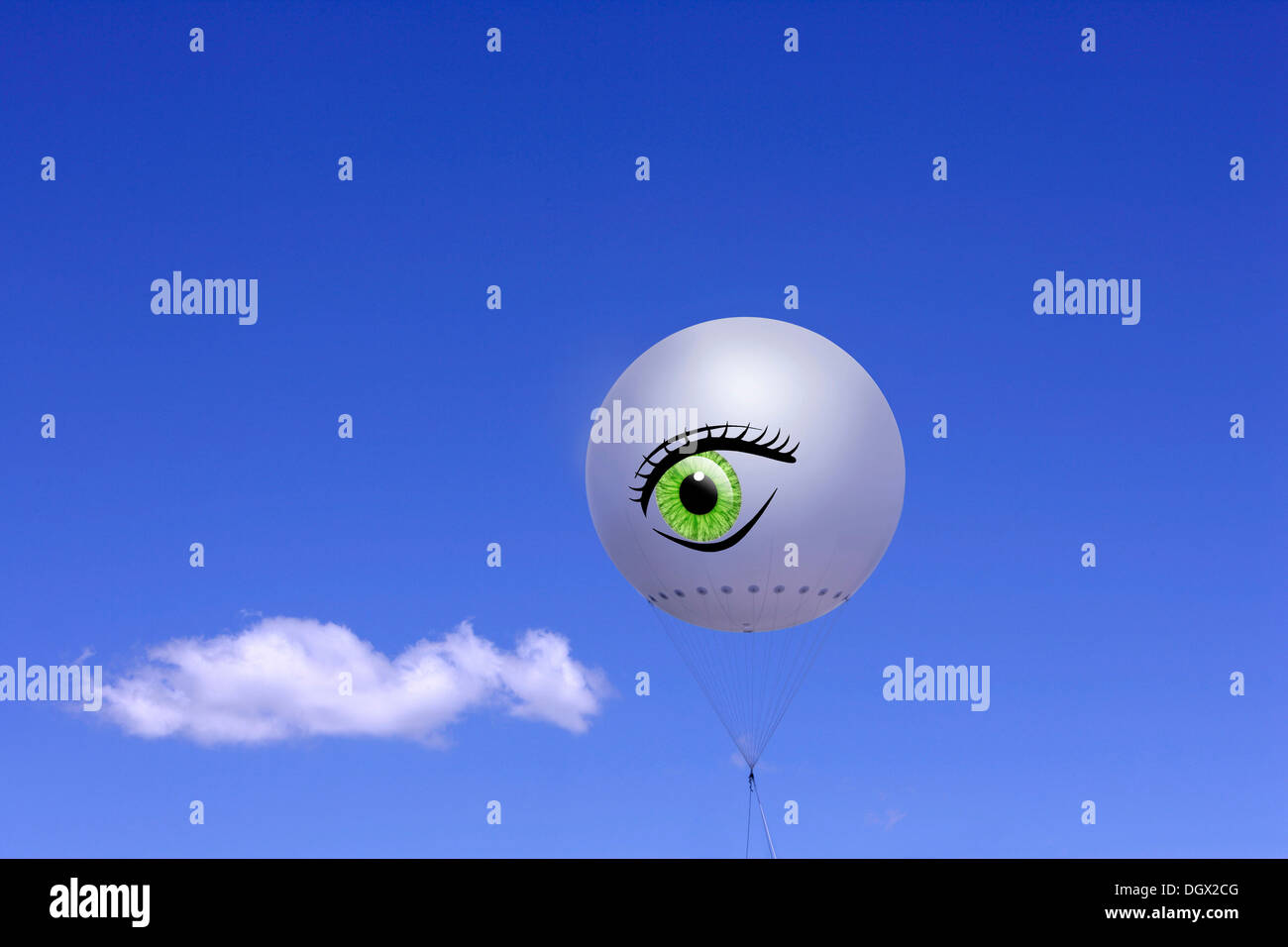 Tethered balloon with the illustration of a human eye against a blue ...