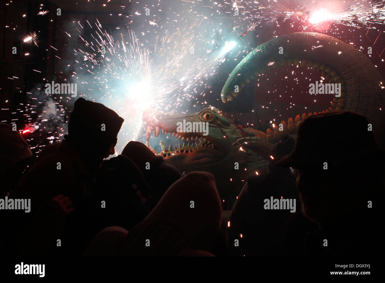 People dance surrounded by fire and pyrotechnics during a traditional ...