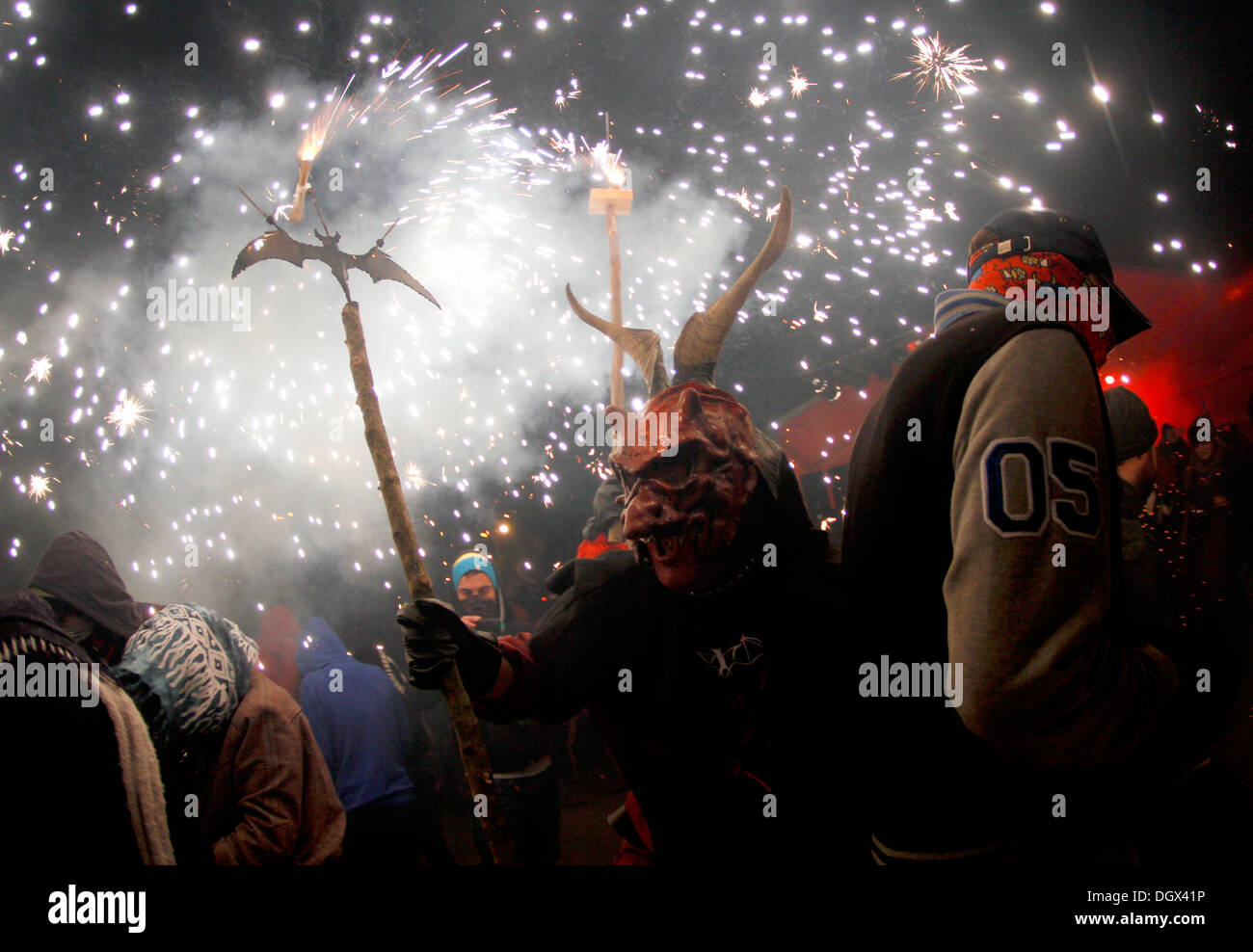 People dance surrounded by fire and pyrotechnics during a traditional ...