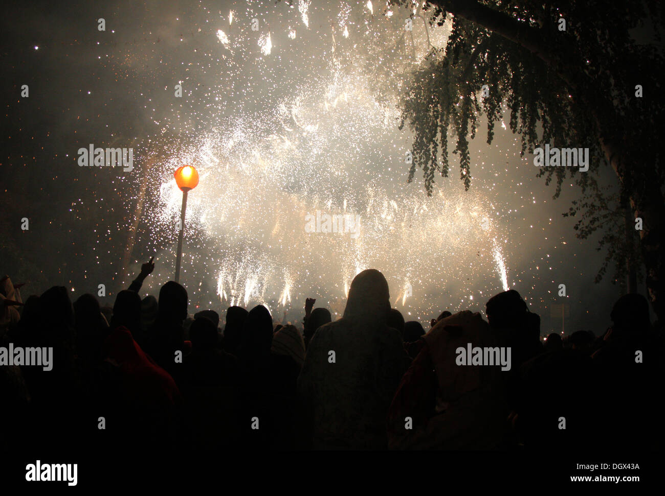 People dance surrounded by fire and pyrotechnics during a traditional ...