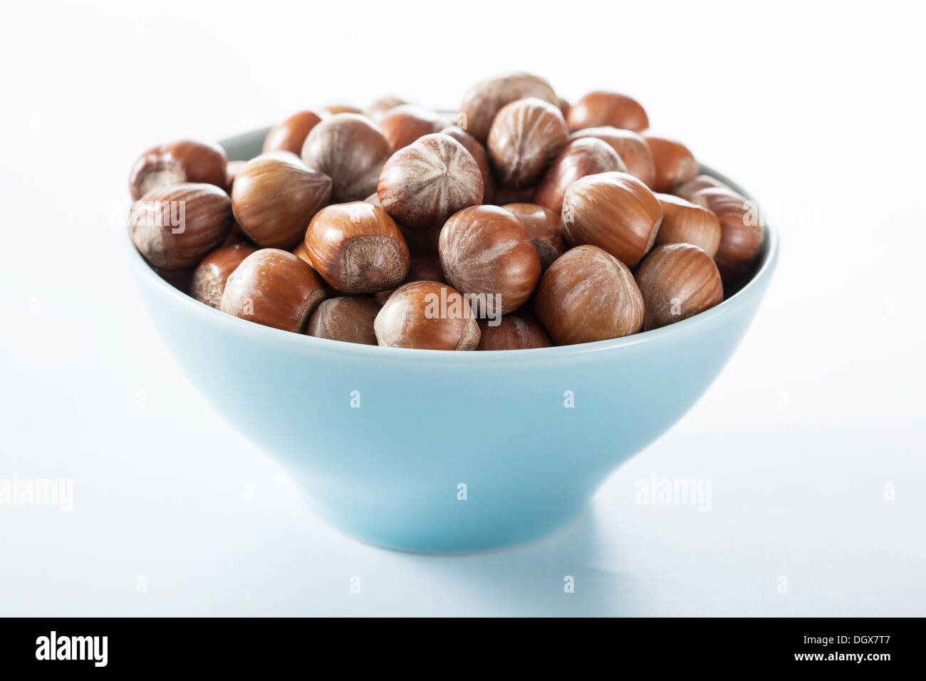 hazelnuts in blue bowl Stock Photo - Alamy