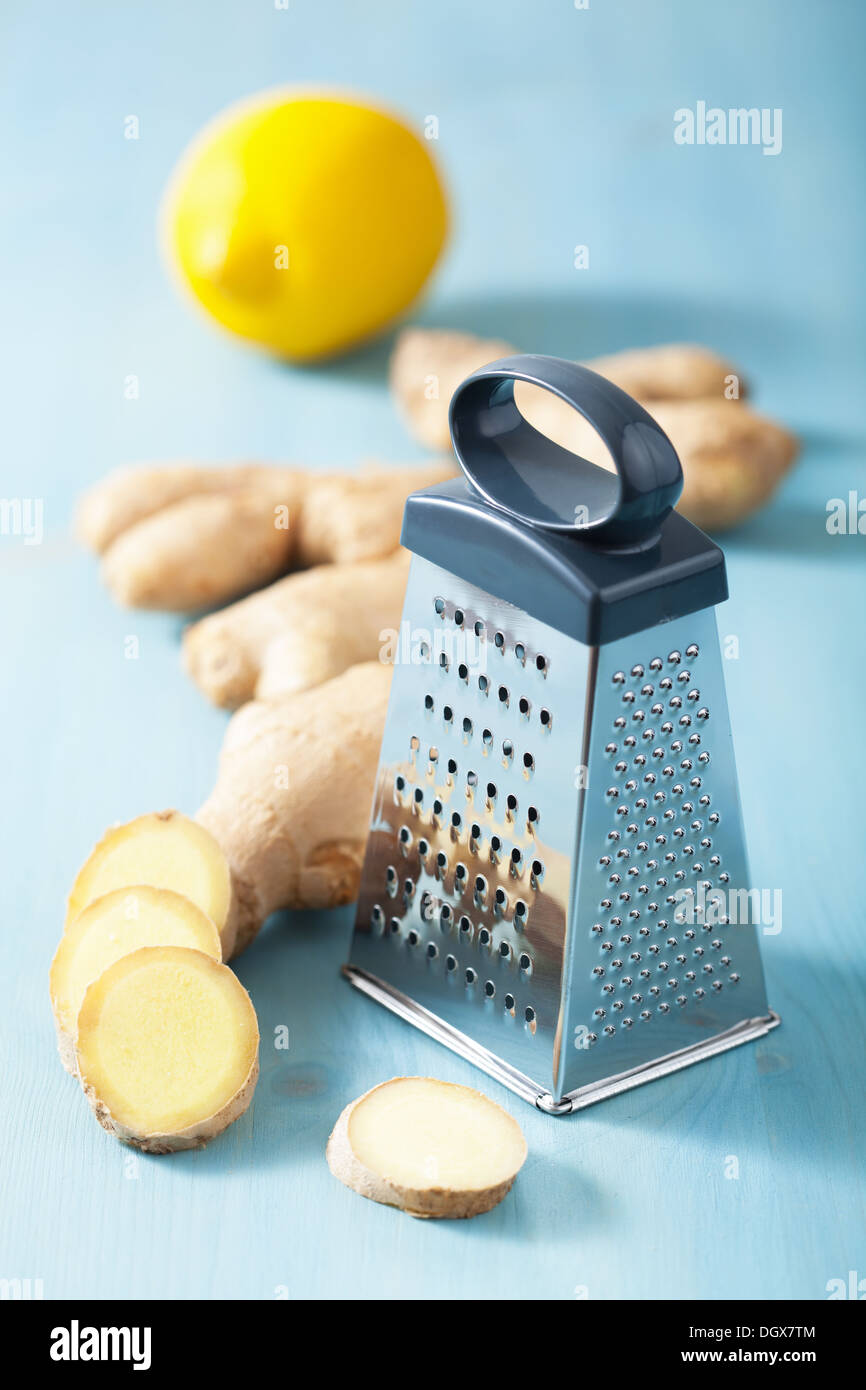 fresh ginger root and grater over blue Stock Photo - Alamy