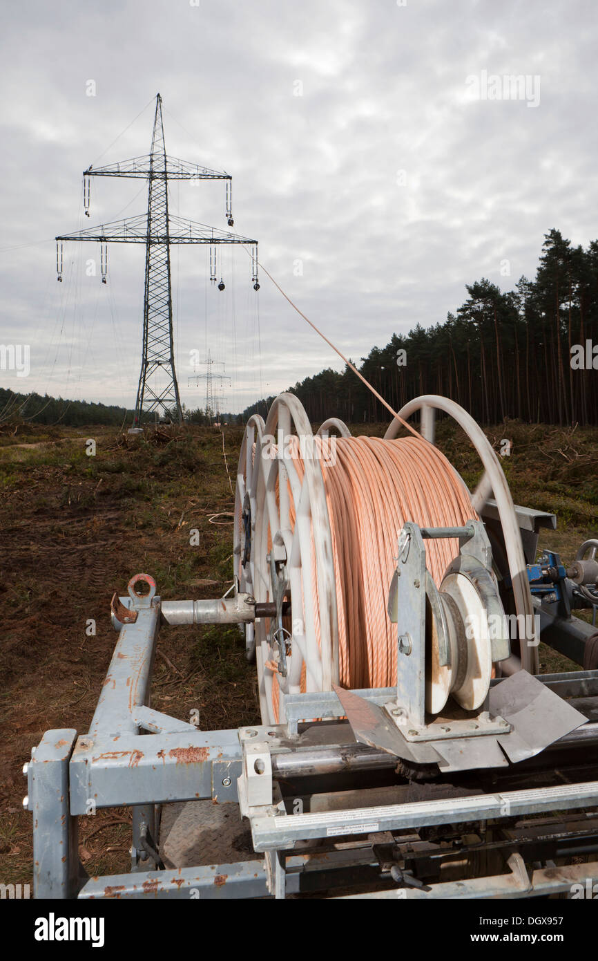 Lineman working with a wire rope hoist on a 380-kV long-distance line ...