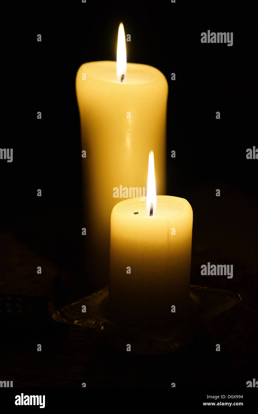 Two candles burning in the dark Stock Photo - Alamy