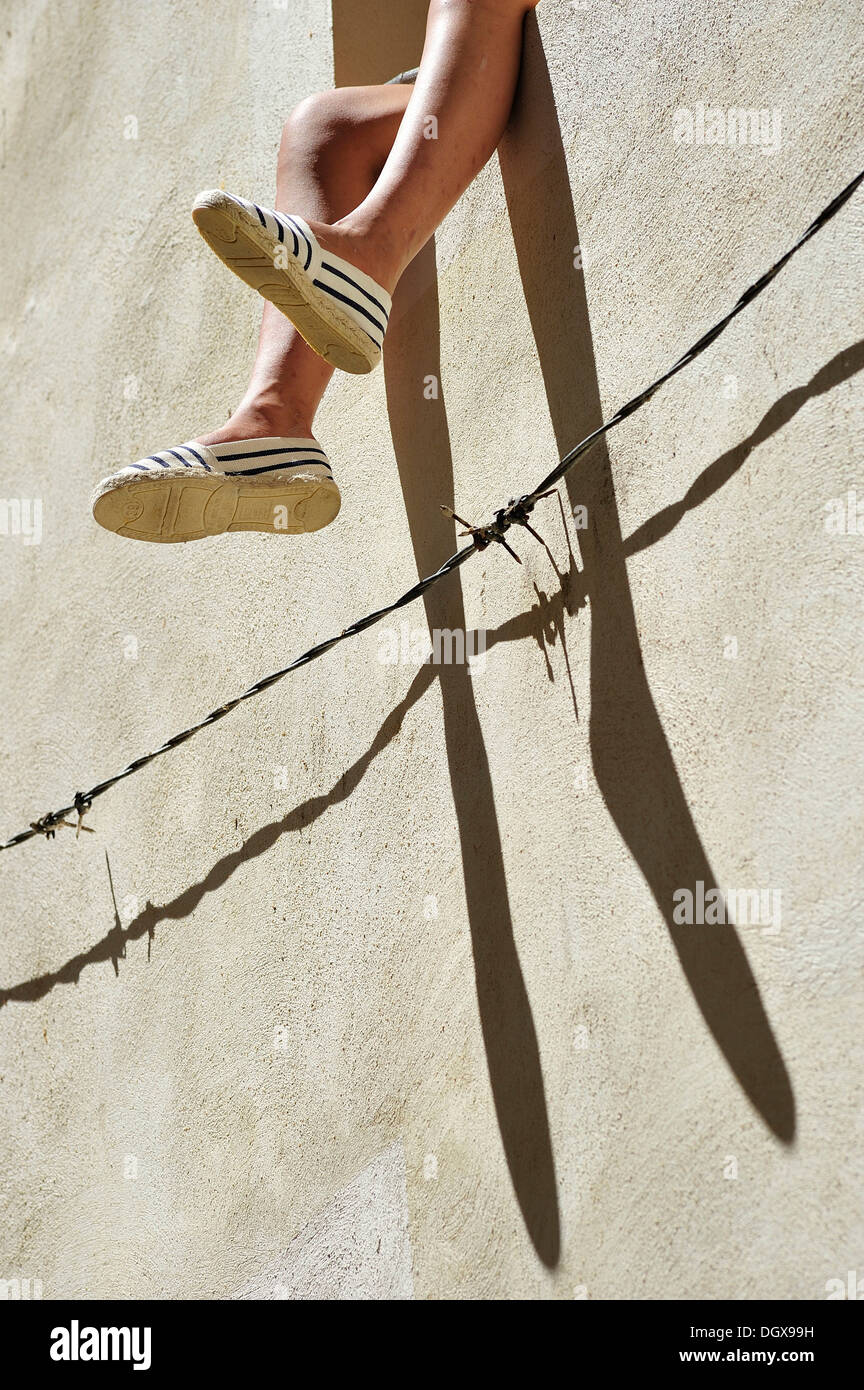 Feet hanging out of a window, Saint-Gilles, Provence, France, Europe ...