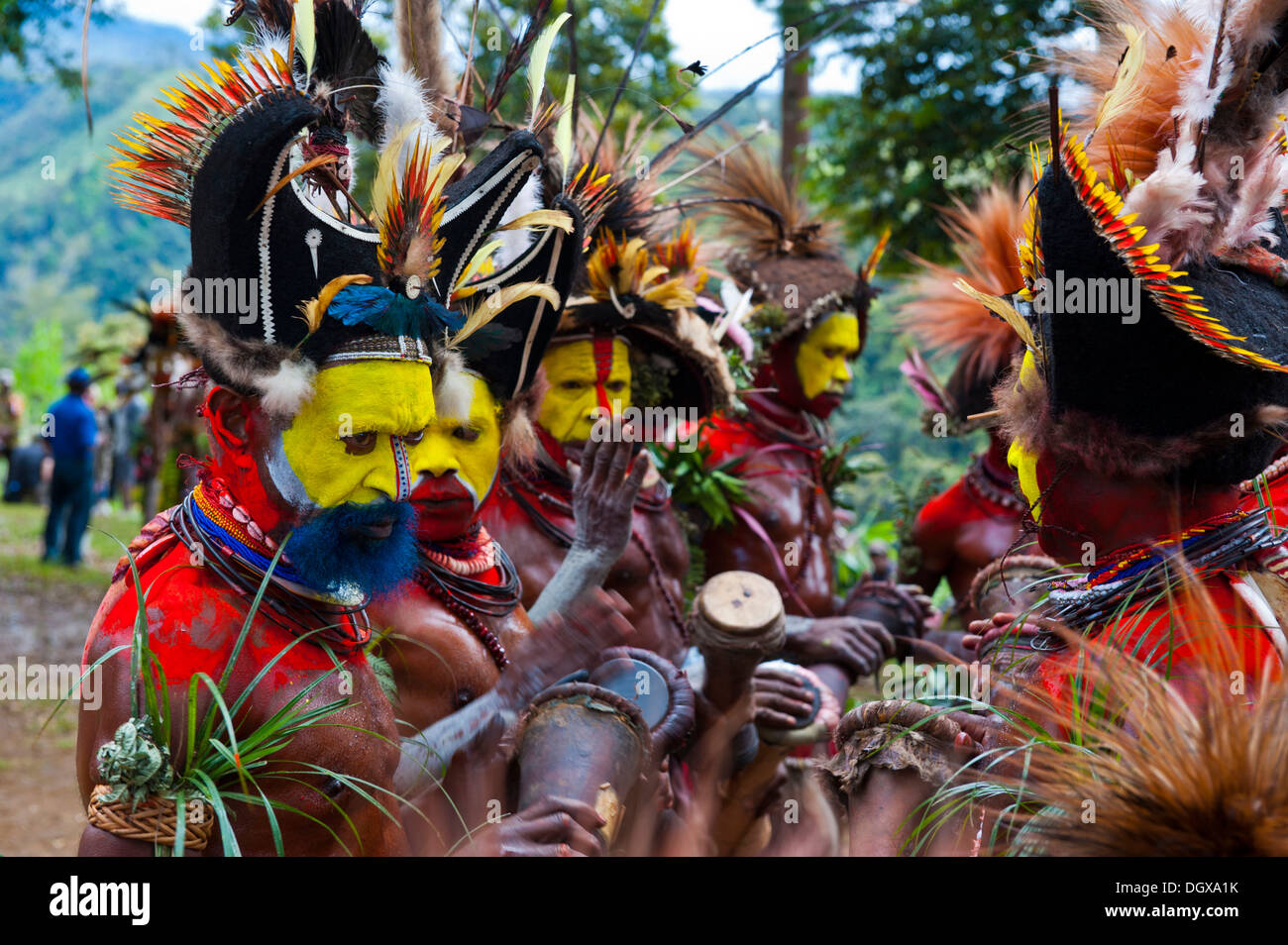 Men with colourful decorations and face paint are celebrating at the ...
