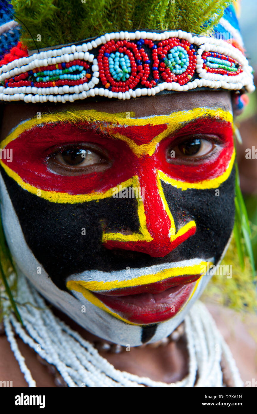 Woman with colourful decorations and face paint is celebrating the ...
