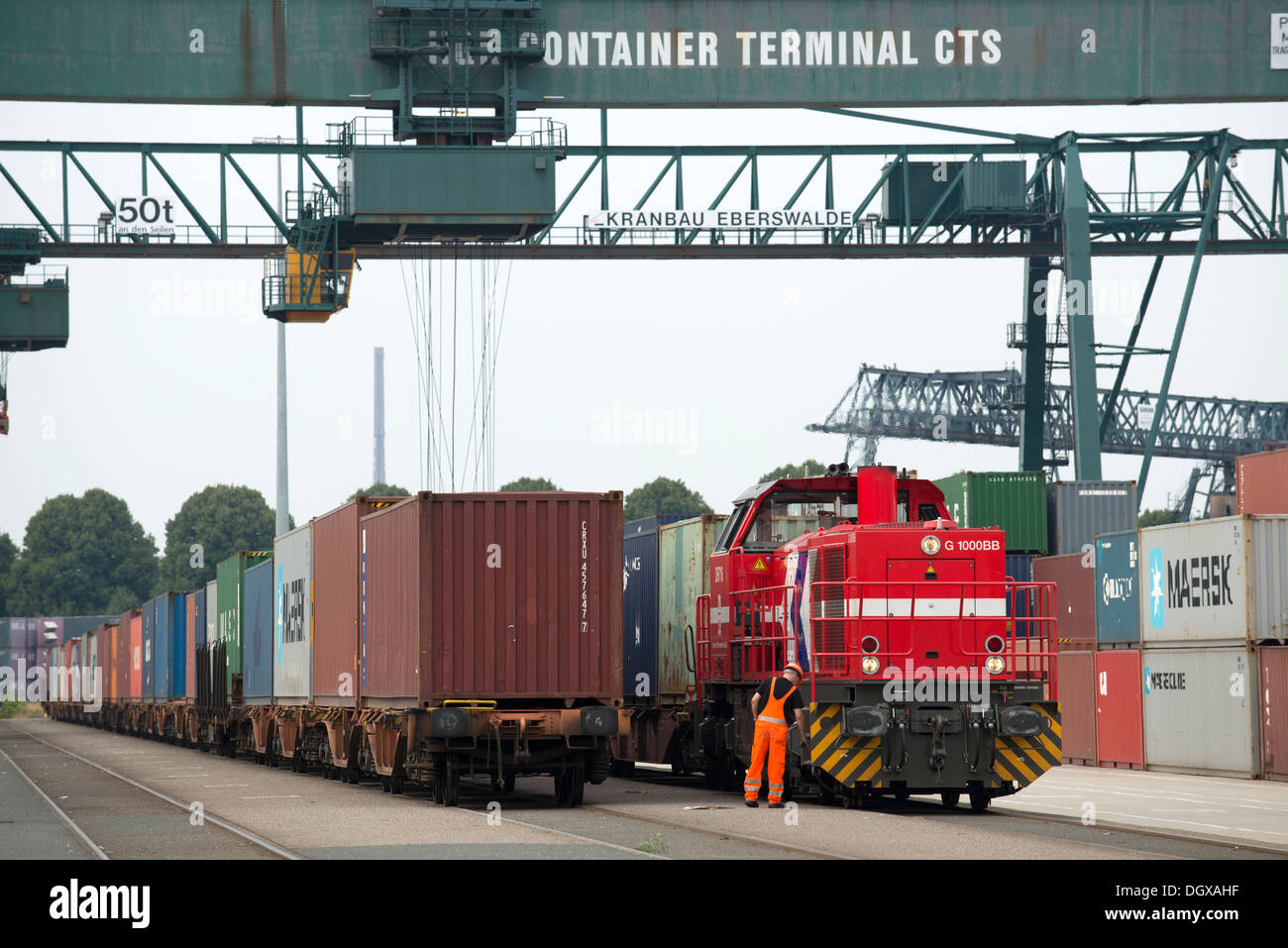 Dock worker making checks on a freight train locomotive Stock Photo - Alamy