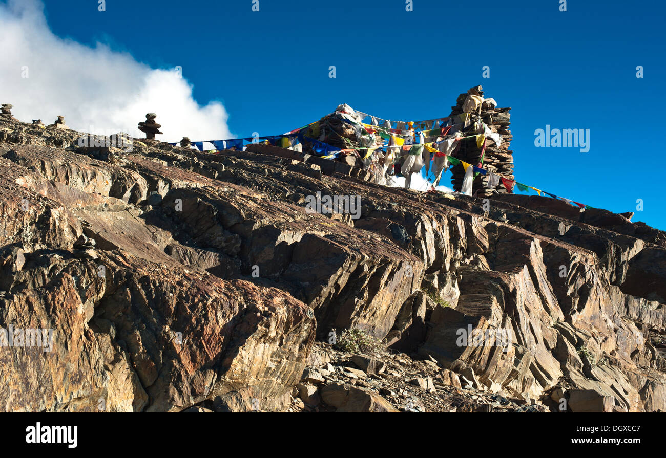 Buddhist stone tower praying flags at Himalaya mountain road pass at ...