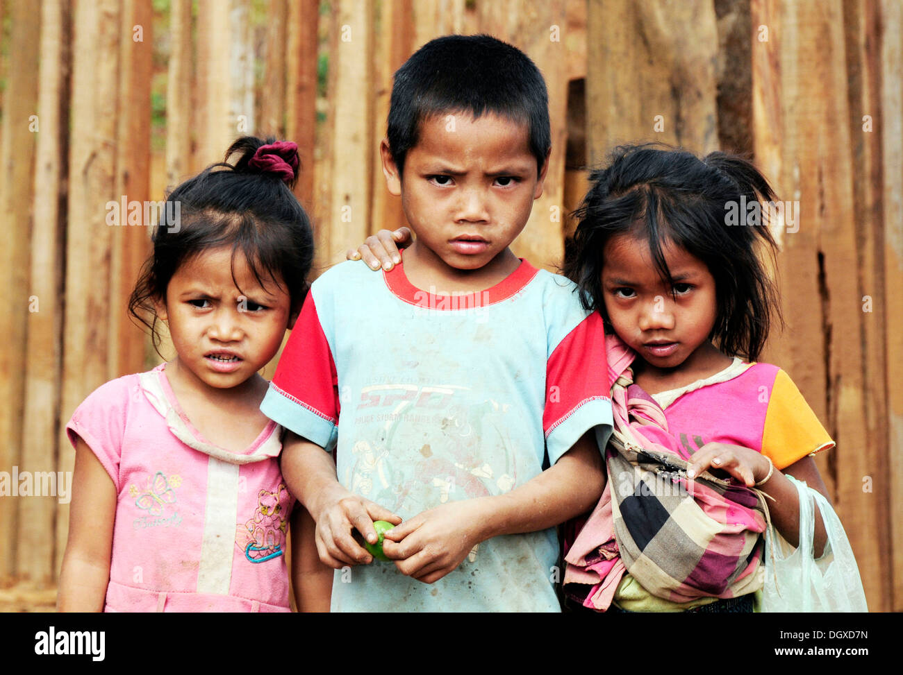 Three children looking critically towards the camera, Laos, Southeast ...