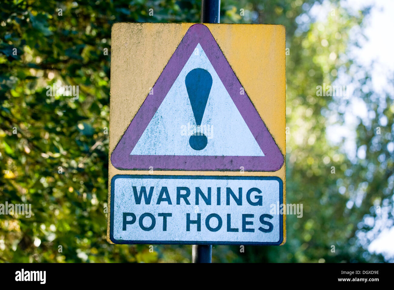 A red warning hazard triangle / triangular sign warning pot hole ...