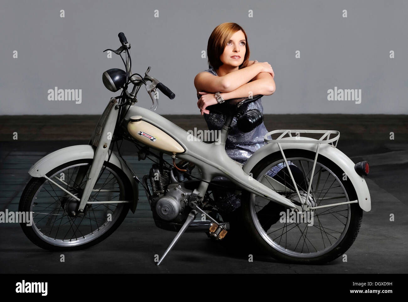 Young woman with a vintage Motom motorcycle Stock Photo - Alamy