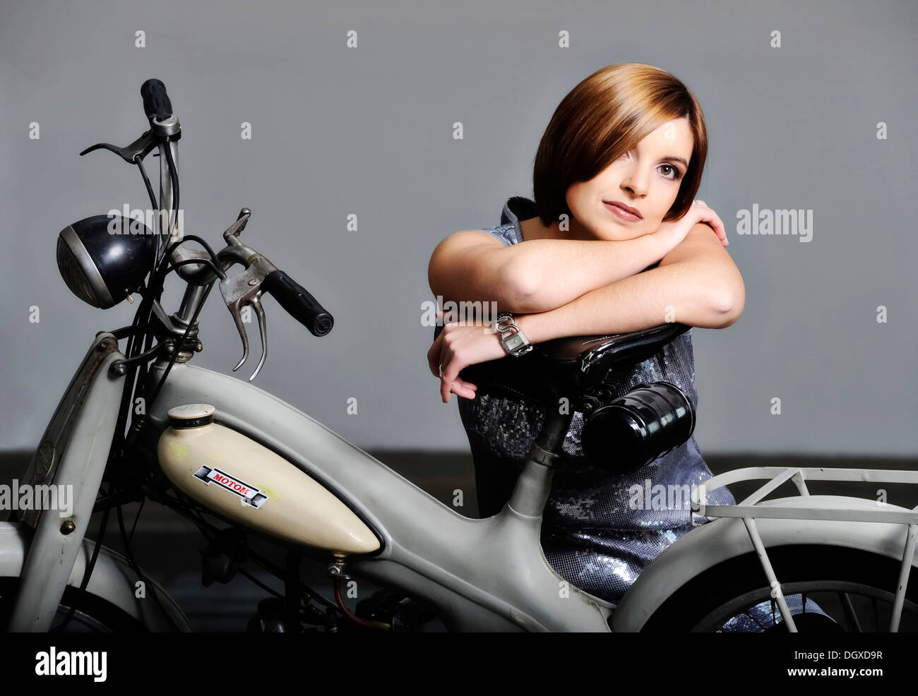 Young woman with a vintage Motom motorcycle Stock Photo - Alamy