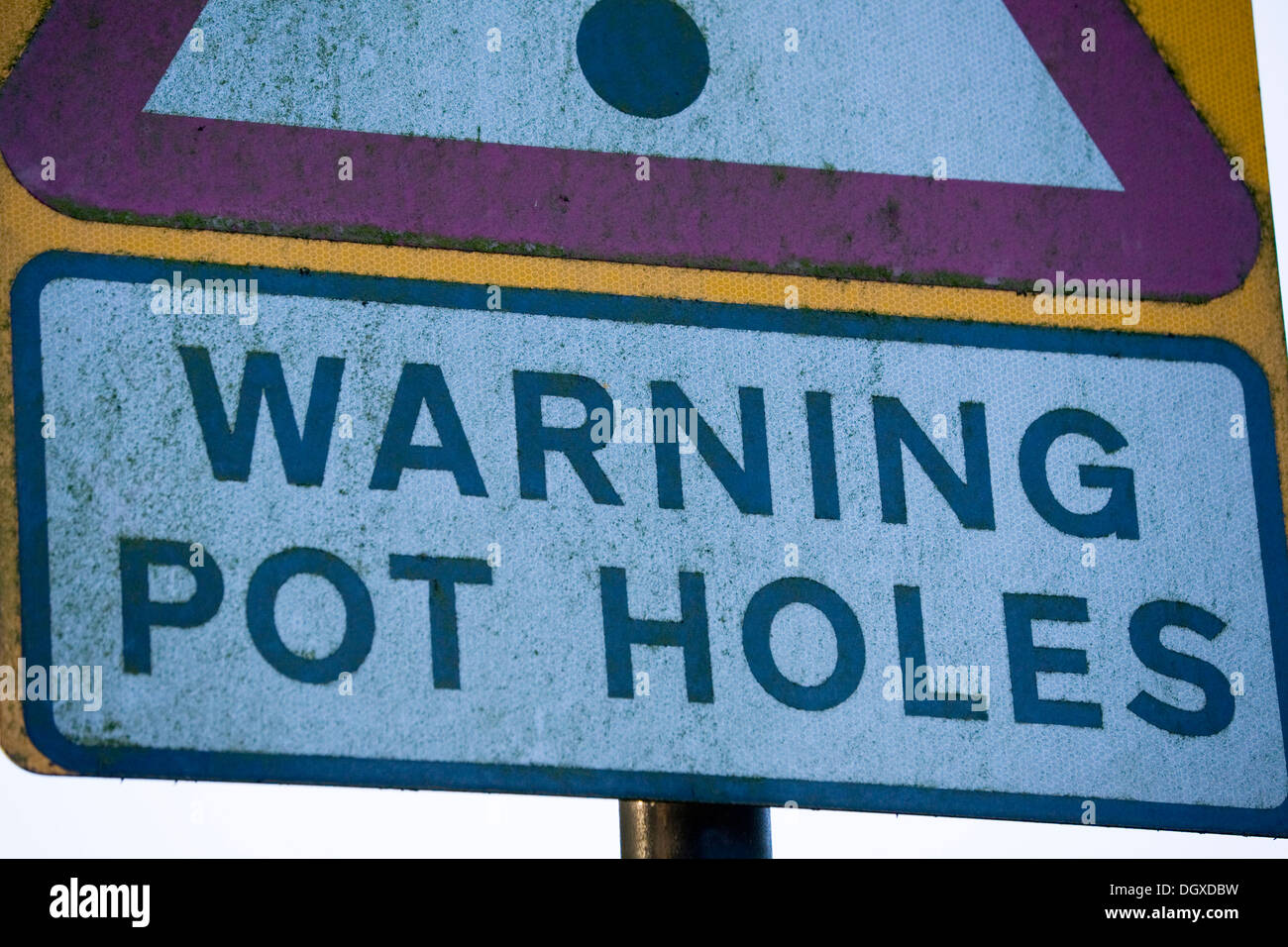A red warning hazard triangle / triangular sign warning pot hole ...