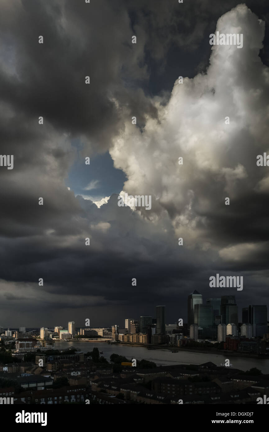 Dark storm clouds loom over the River Thames and Canary Wharf buildings ...