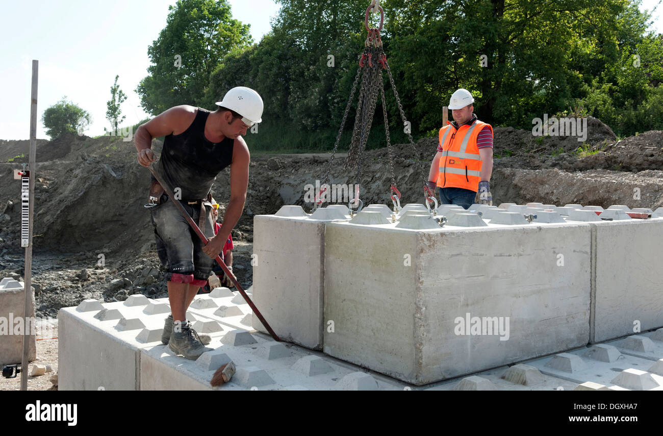 Structural engineers placing the first blocks during a building site ...