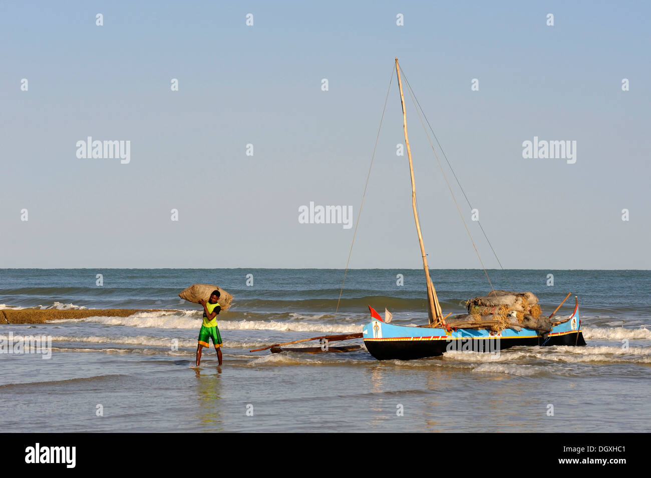 Malagasy man unloading a pirogue, Morondava, Madagascar, Africa Stock ...