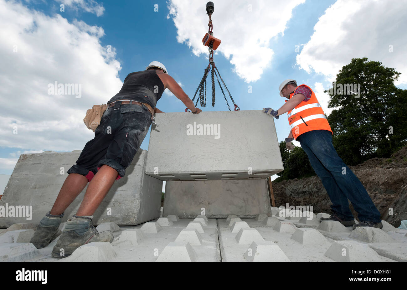 Structural engineers placing the first blocks during a building site ...
