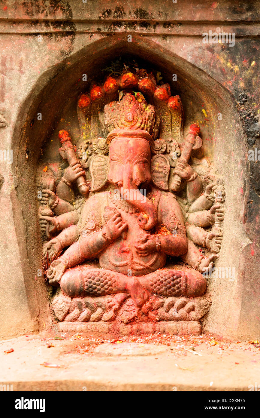 Sculpture of the Hindu god Ganesh, dusted with red powder, Kathmandu ...