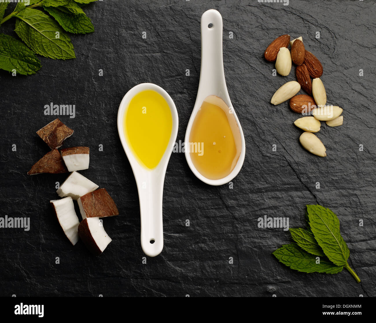 Spoons full of oil with fresh ingredients Stock Photo - Alamy