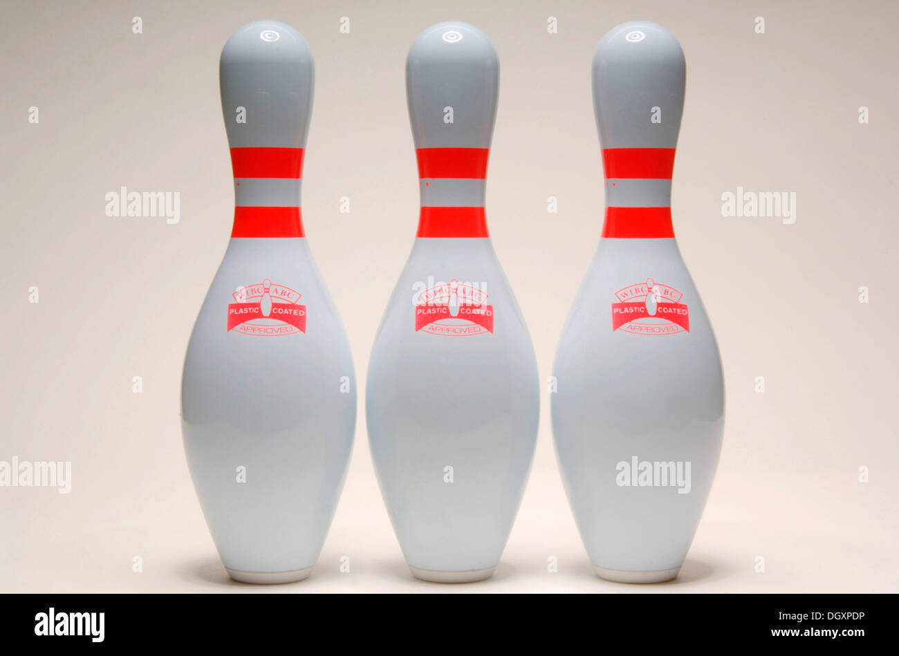 Three bowling pins lined up together Stock Photo - Alamy