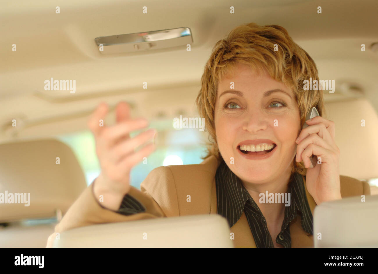 Businesswoman making a phone call in a car Stock Photo - Alamy