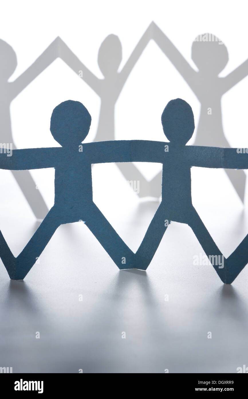 paper cutout of people. concept of people coming together and working ...