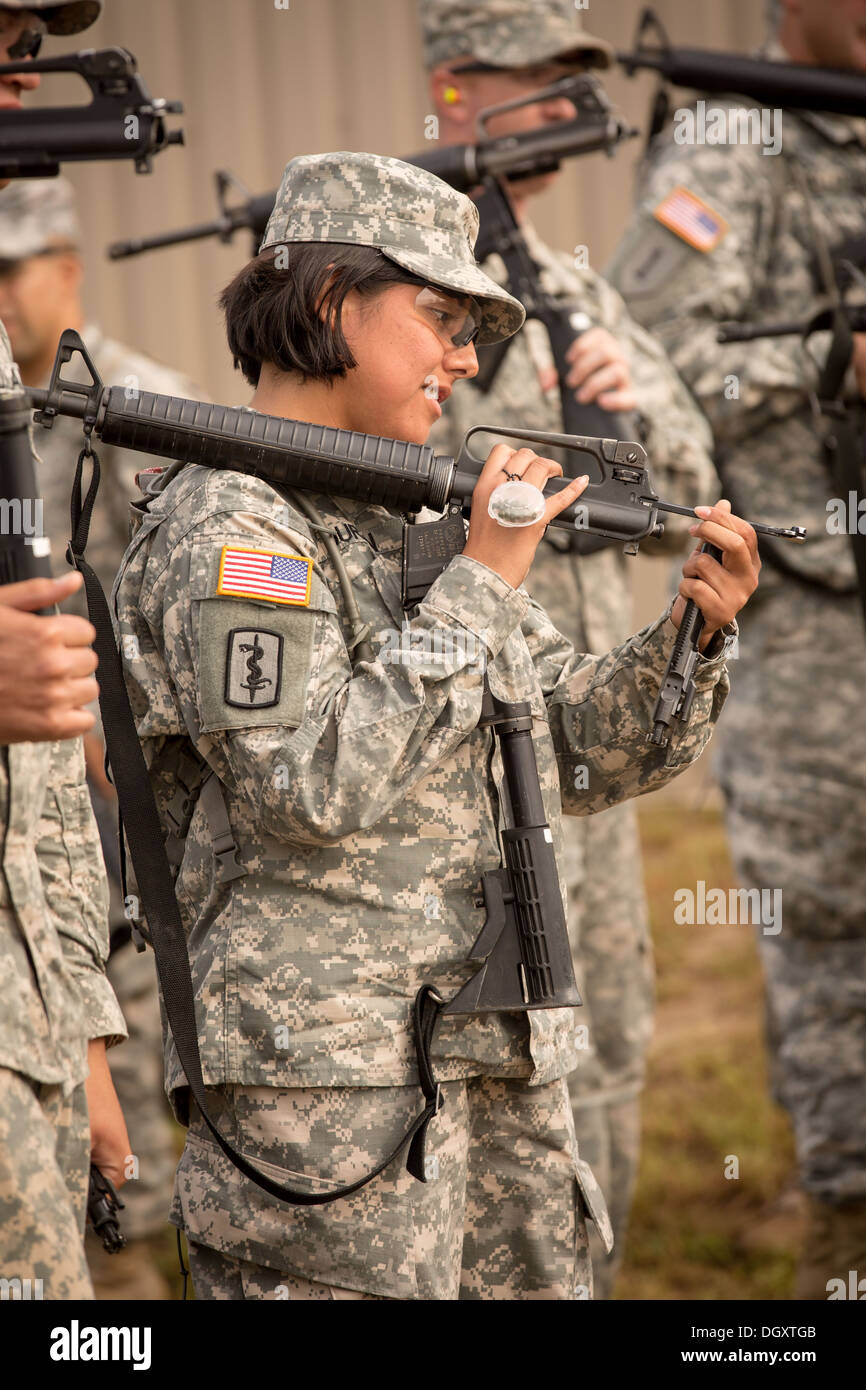 A woman Drill Sergeant candidate prepares her weapon for inspection at ...