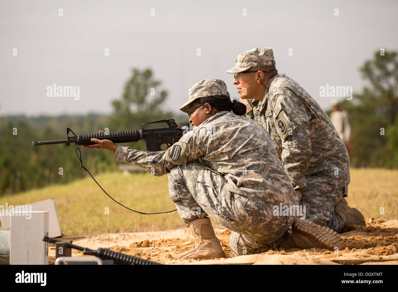 A woman Drill Sergeant candidate prepares to fire her rifle at the US ...